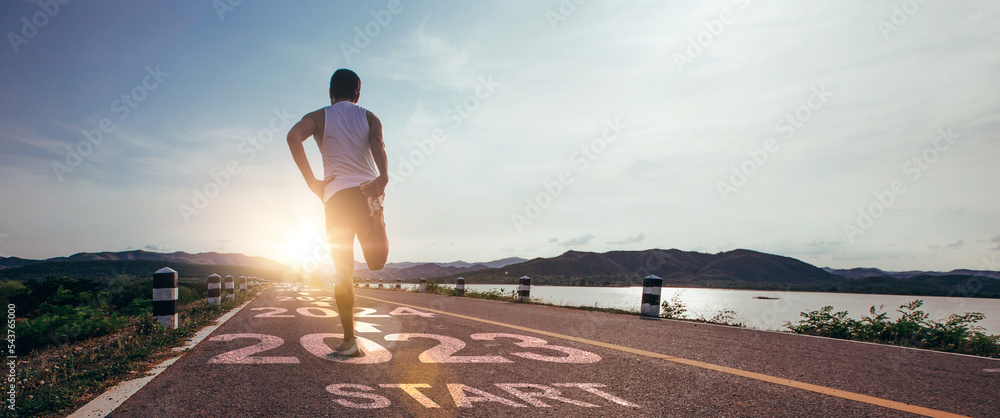 Runners stretch their legs and prepare to run to welcome the new year ...