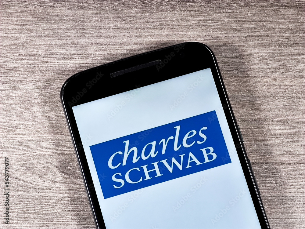 Charles Schwab logo on phone screen. The Charles Schwab Corporation is ...