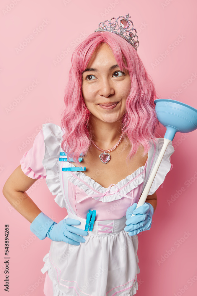 Pensive dreamy pink haired housemaid thinks what to do after cleaning ...