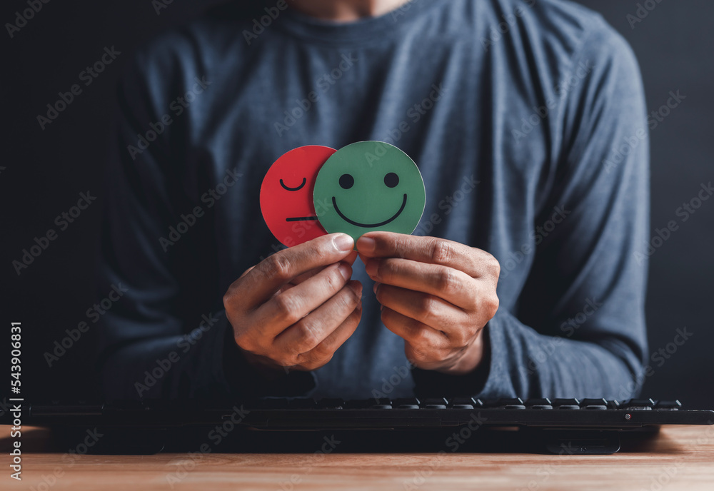 Man Hands holding sad face hiding or behind happy smiley face, bipolar ...