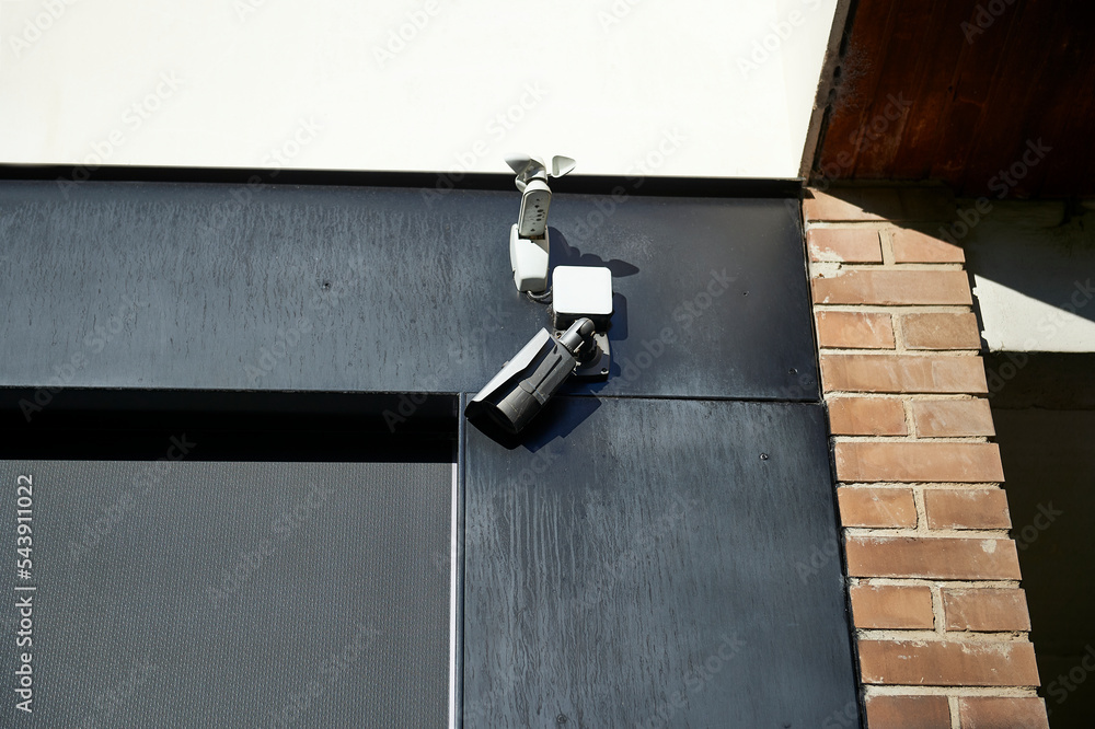 video surveillance camera with anemometer anchored to a brick wall and ...