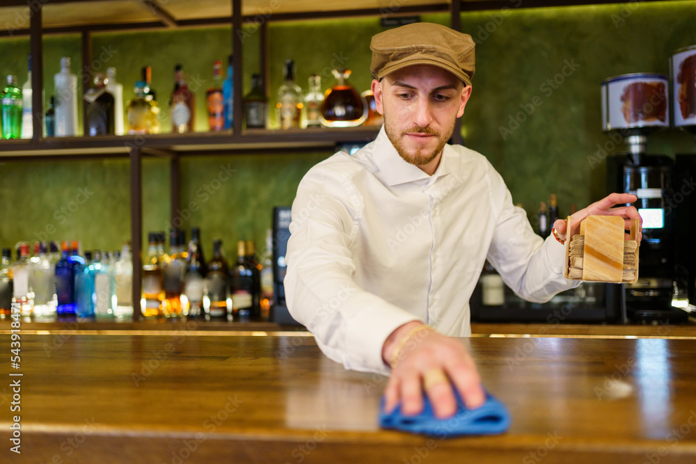 Bartender cleaning counter in a nice pub Stock Photo | Adobe Stock