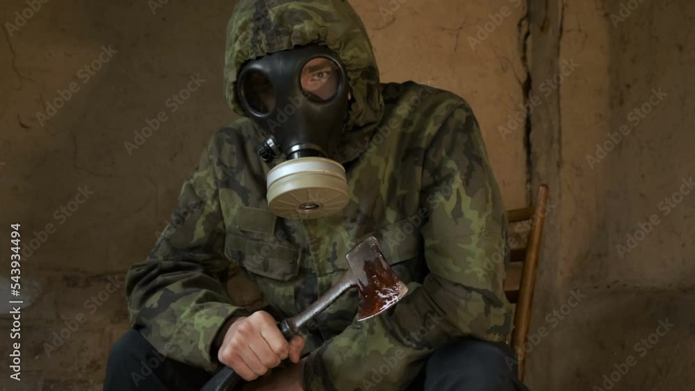 Apocalypse concept. A Man Axe Murderer In A Gas Mask with bloody axe ...
