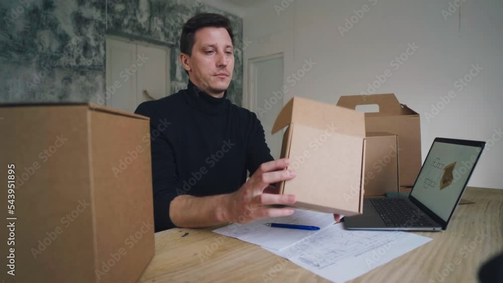 Designer works, develops packaging design using computer and drawing ...