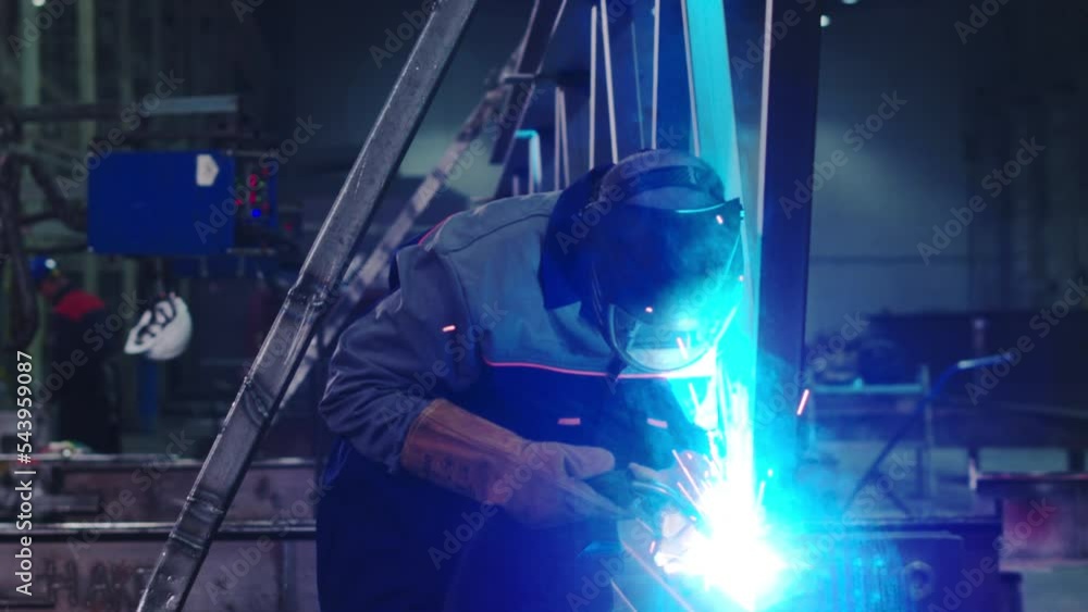 Modern metalwork workshop. Workers in the process of welding metal ...