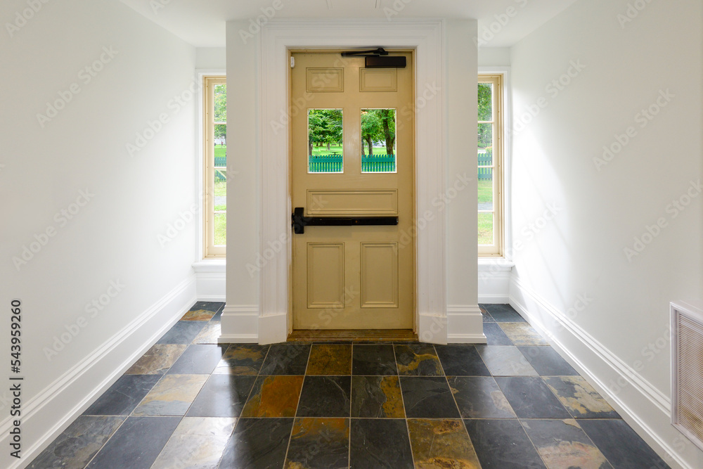 The interior of a bright and light hallway of an office building. The ...