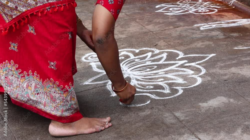 Indian women putting kolam Rangoli for Pongal front of Indian Temple ...