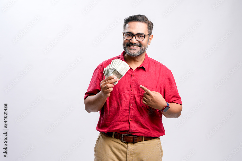 Indian man showing currency on white background. Stock Photo | Adobe Stock