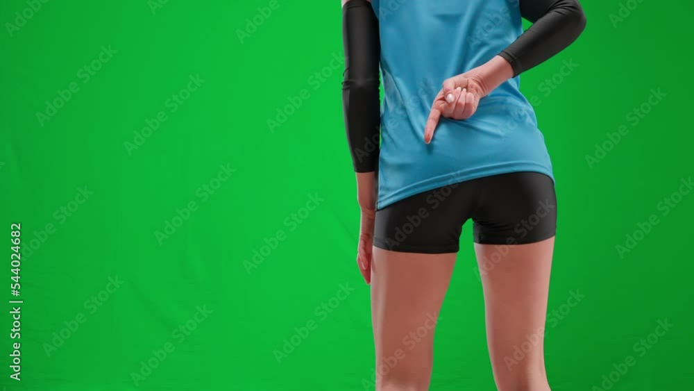Back view of female volleyball player showing finger gestures behind ...