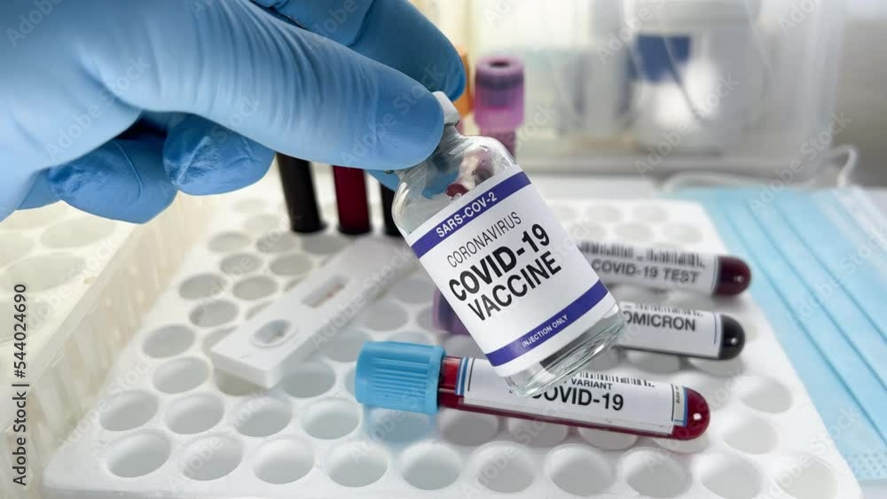 Medical bench with blood samples and Doctor holding vial for ...