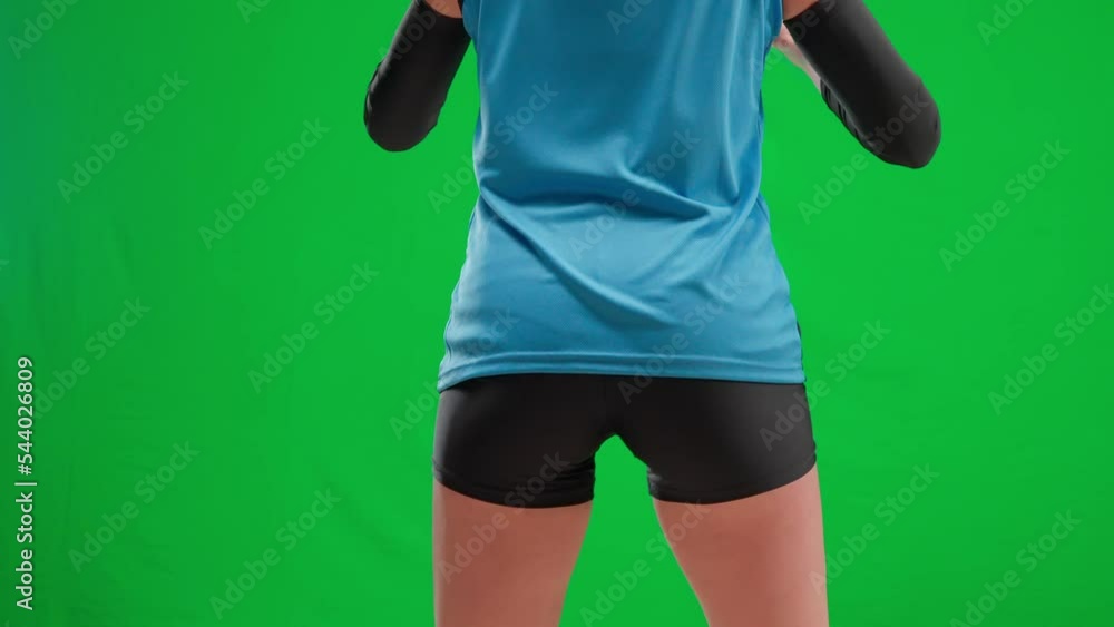 Back view of female volleyball player showing finger gestures behind ...