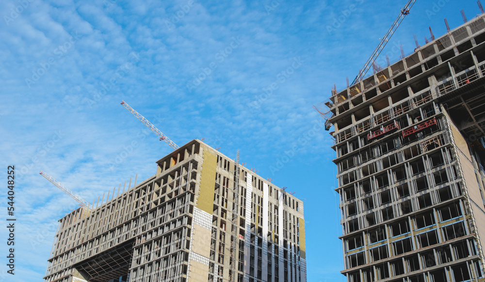 Construction site. Construction cranes and a building under ...