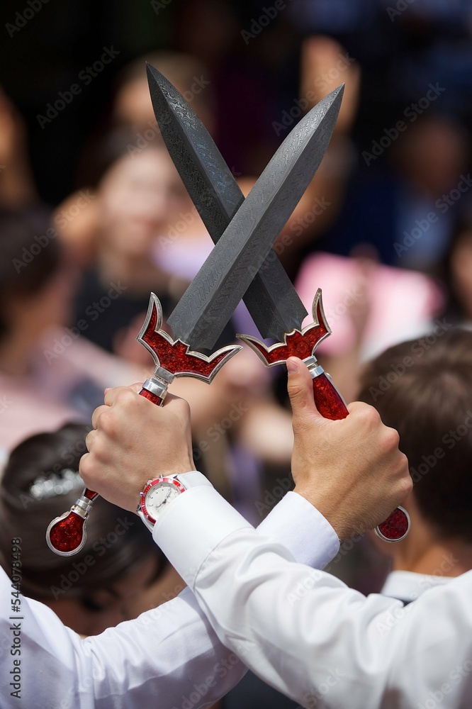 Two swords in men's hands. A symbol of protection as a tradition of ...