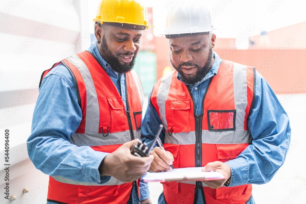 Two black african male professional engineers doing routine checkup on ...