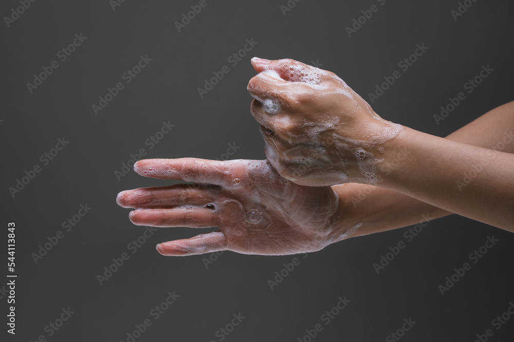 Lady washing hand rubbing with soap to prevent the spread of bacteria ...