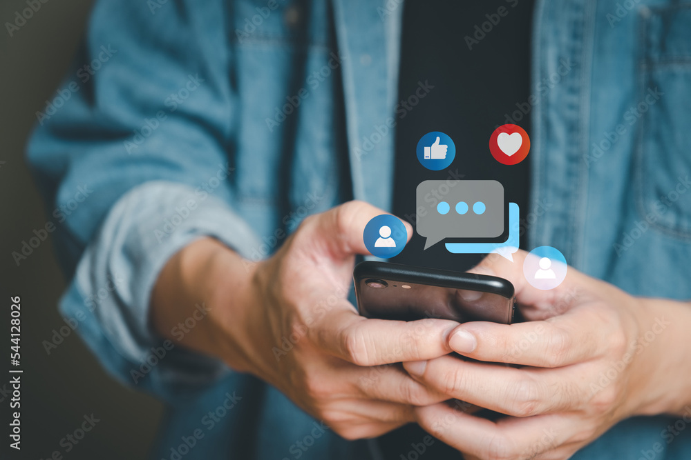 Selective focus at men hand while type on smartphone while chat and ...