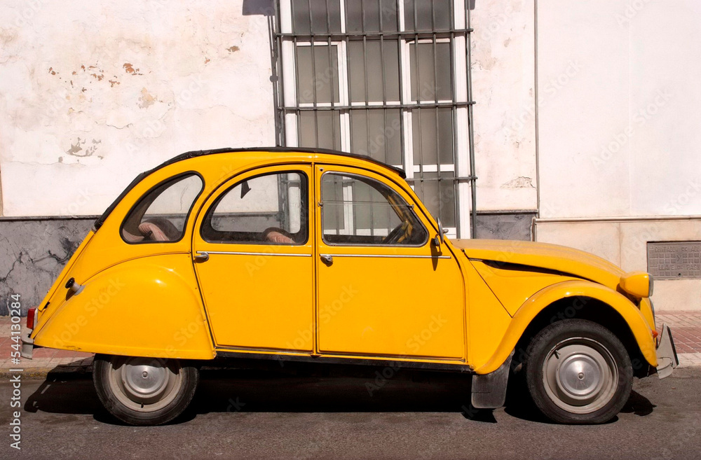 Yellow Citroen 2 CV in front of an old facade Stock Photo | Adobe Stock