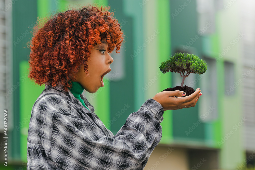 girl or woman expression of surprise with tree in hands, sustainability ...