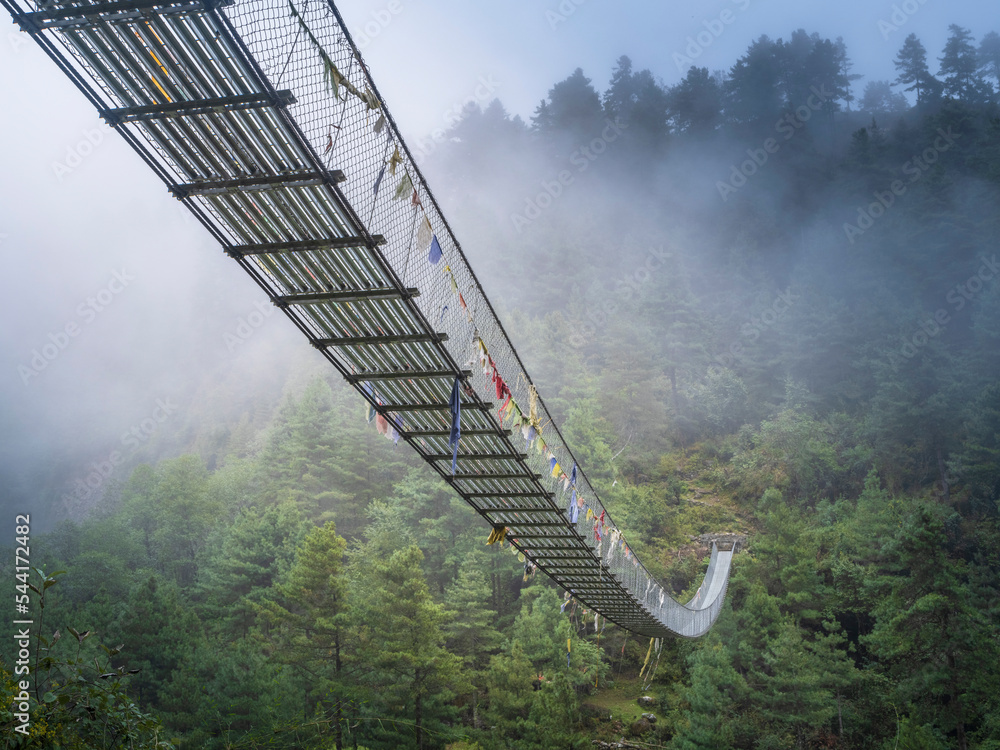 Foto de Hanged chain bridge in foggy forest in Nepal do Stock | Adobe Stock