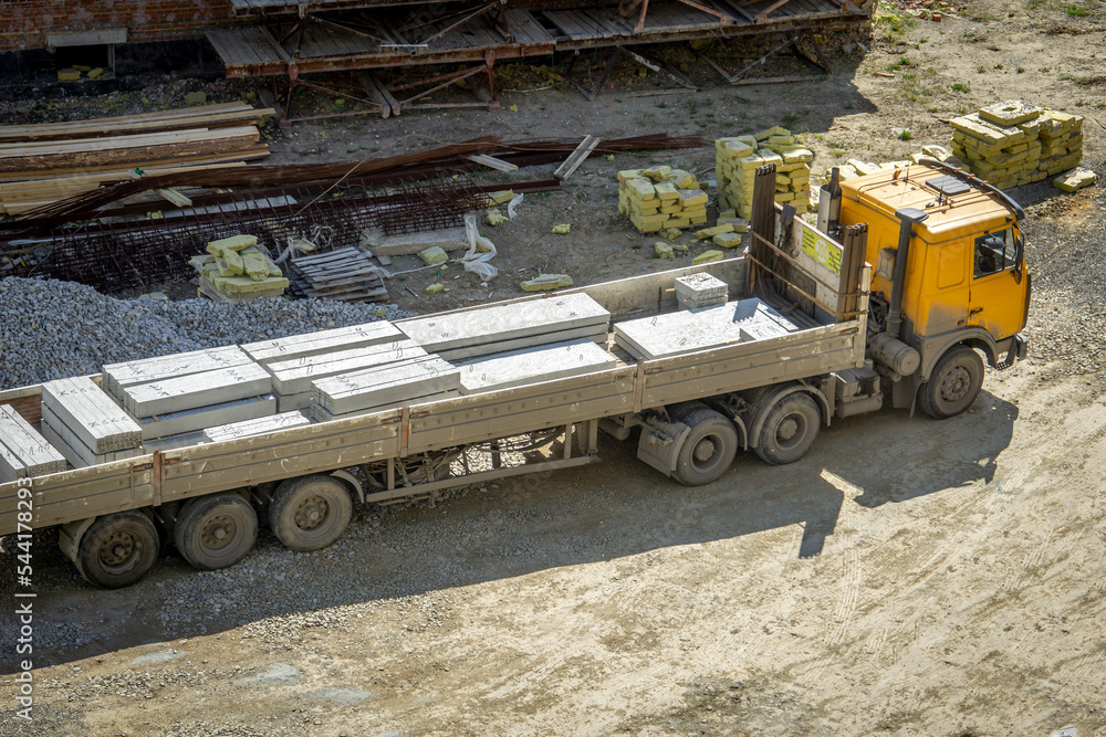 Concrete slabs and blocks in the back of a truck. Delivery of materials ...
