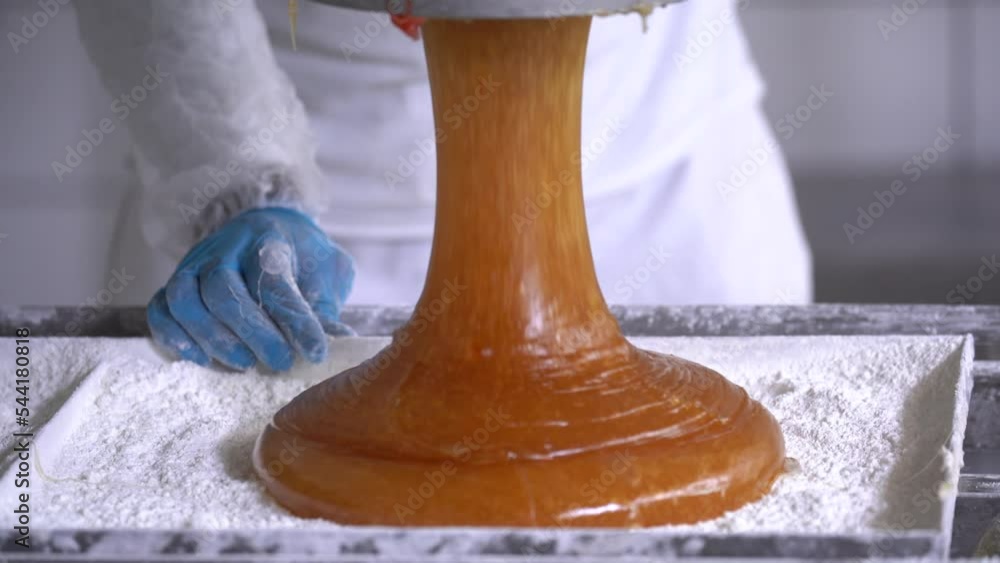 Turkish delight with pistachio poured from a Turkish delight tank into ...