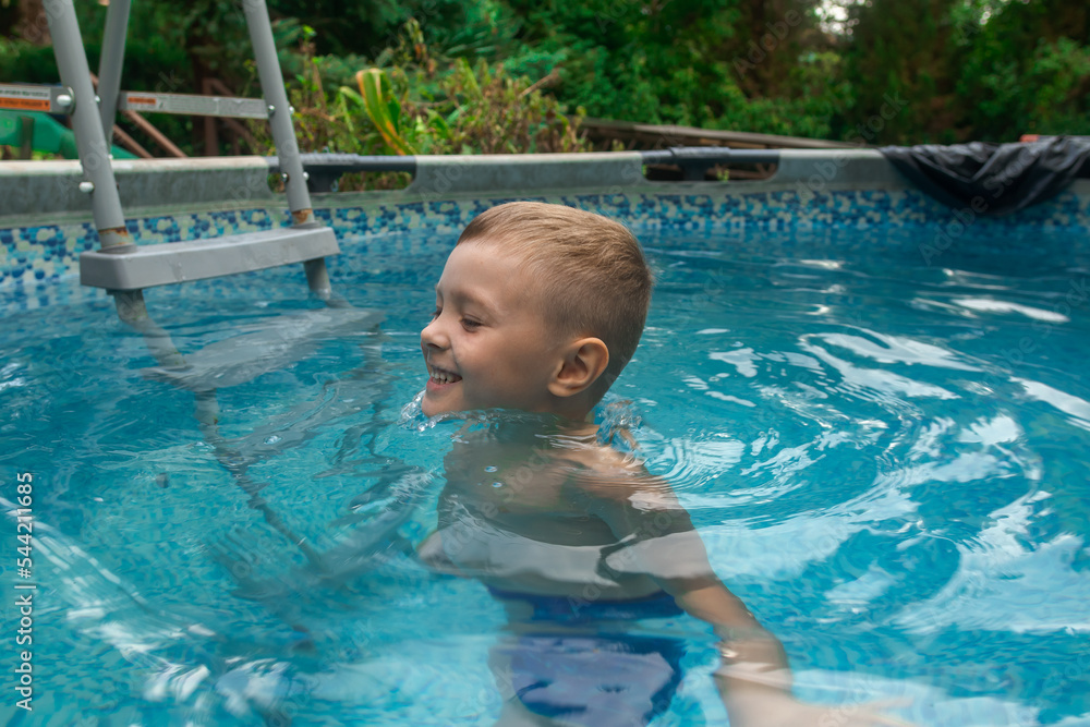 Young kid having fun in the swimming pool. outdoor pool with cold water ...