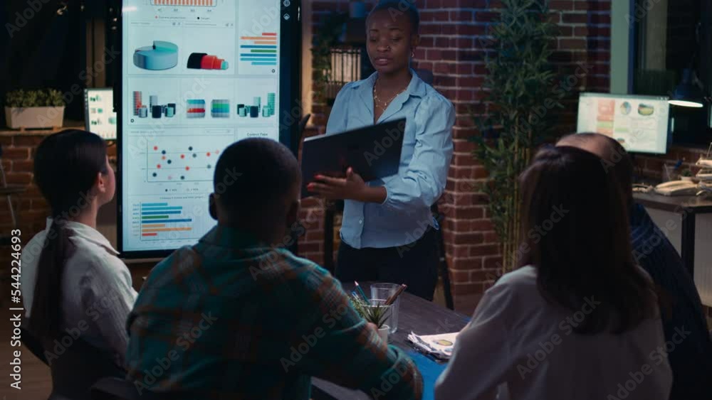 Employee presenting financial report, showing charts on laptop screen ...