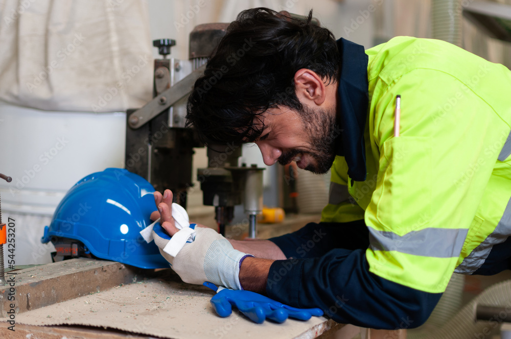 Engineer or worker man wearing uniform had a hand accident on machine ...