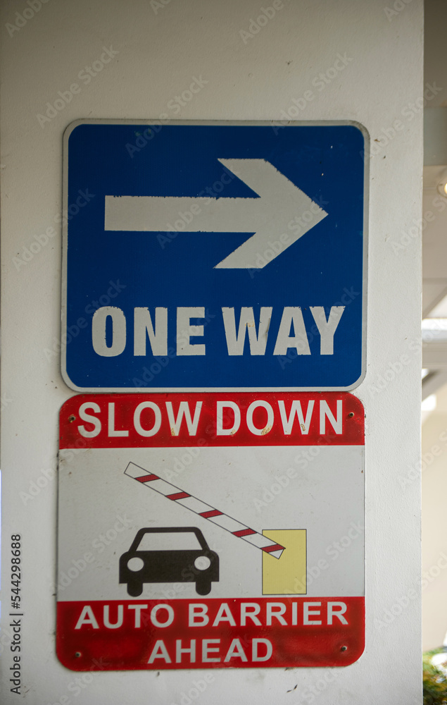 One way and Slow down signs posted on the school post near the exit ...