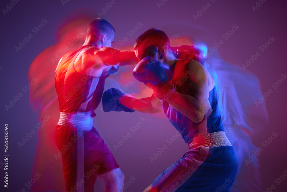 Unfocused effect portrait of two professional boxers boxing isolated on ...