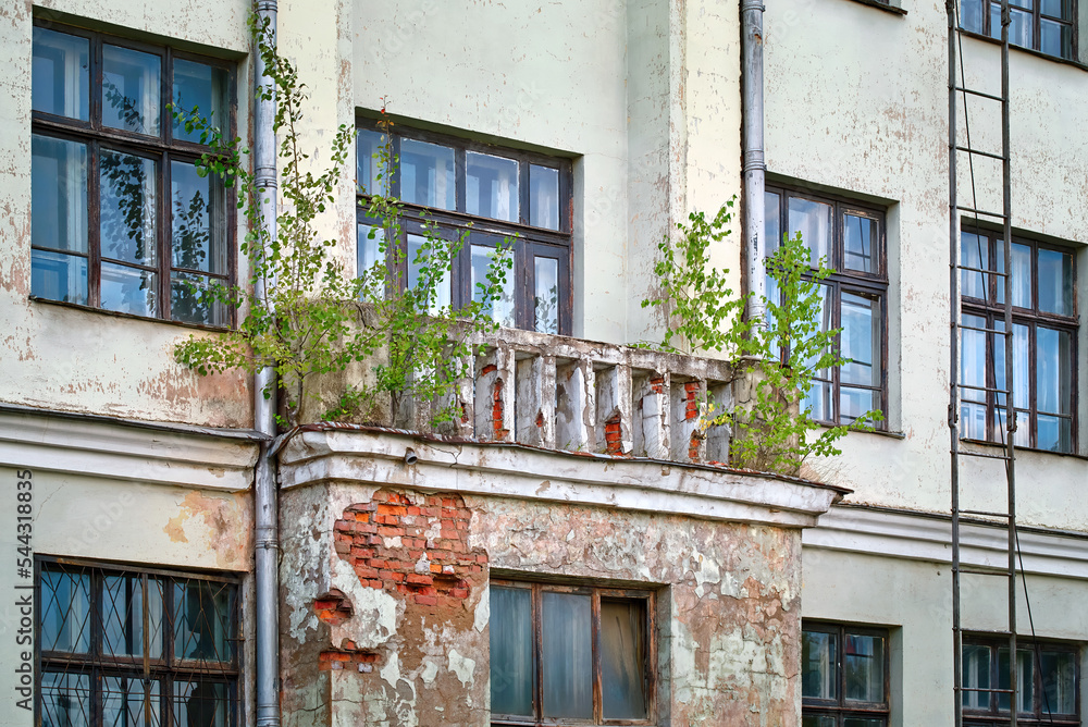 Abandoned building with damaged balcony. Old balcony on building facade ...