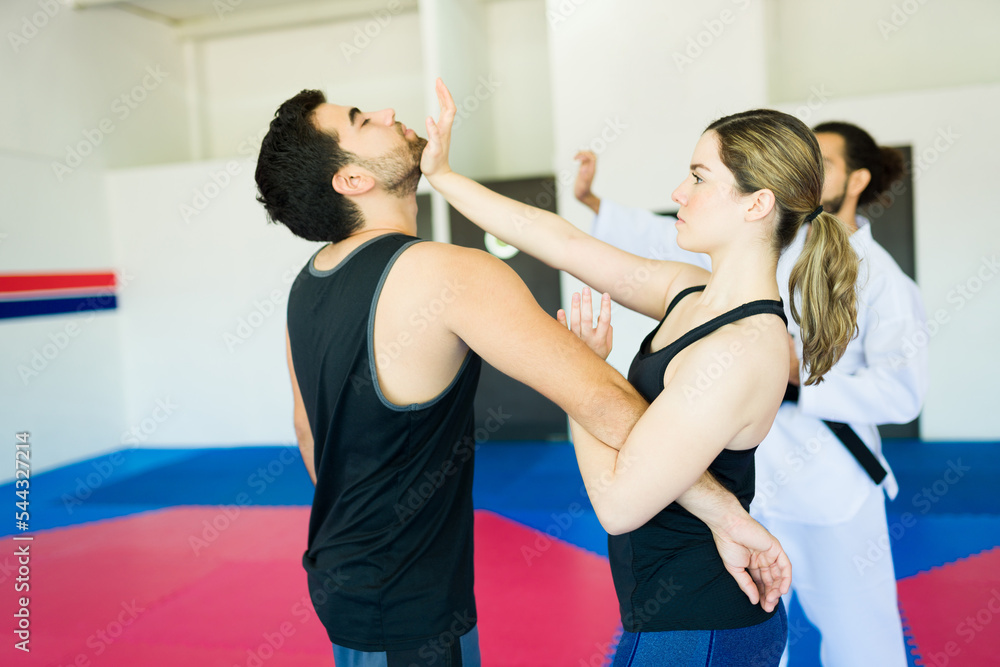 Woman defending from an attacker during a self-defense class Stock ...