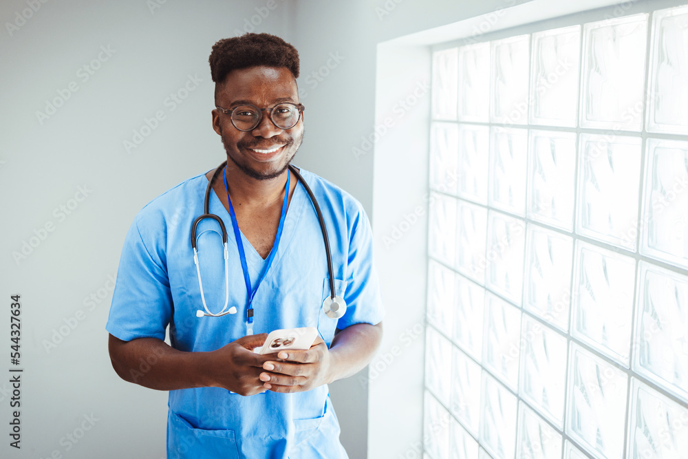 Cheerful male nurse or doctor smiles confidently at the camera ...