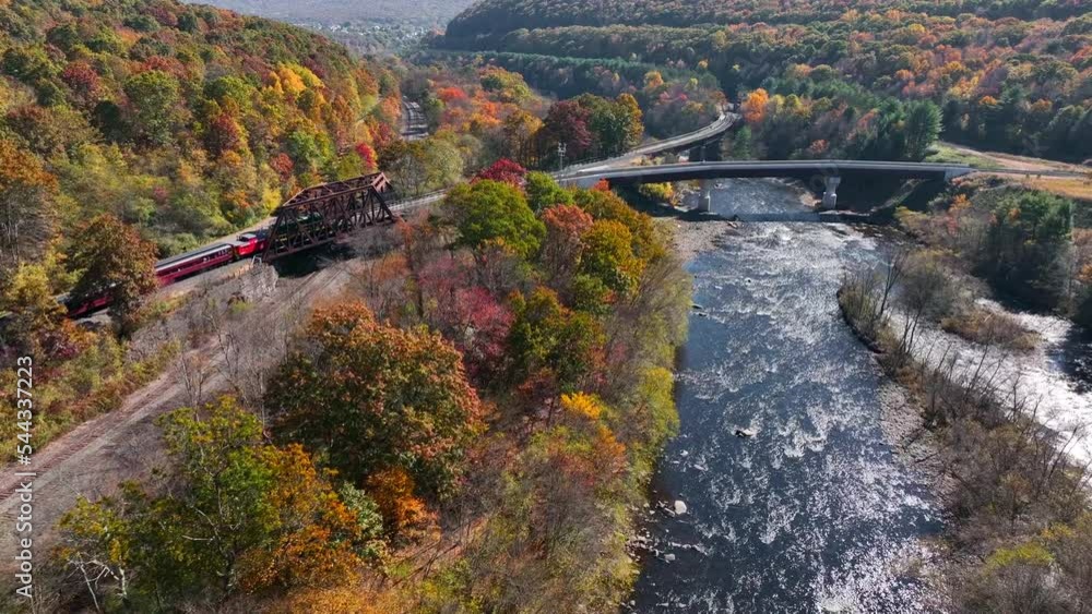 Lehigh Gorge Scenic Rail train passes over bridge. Fall autumn foliage ...