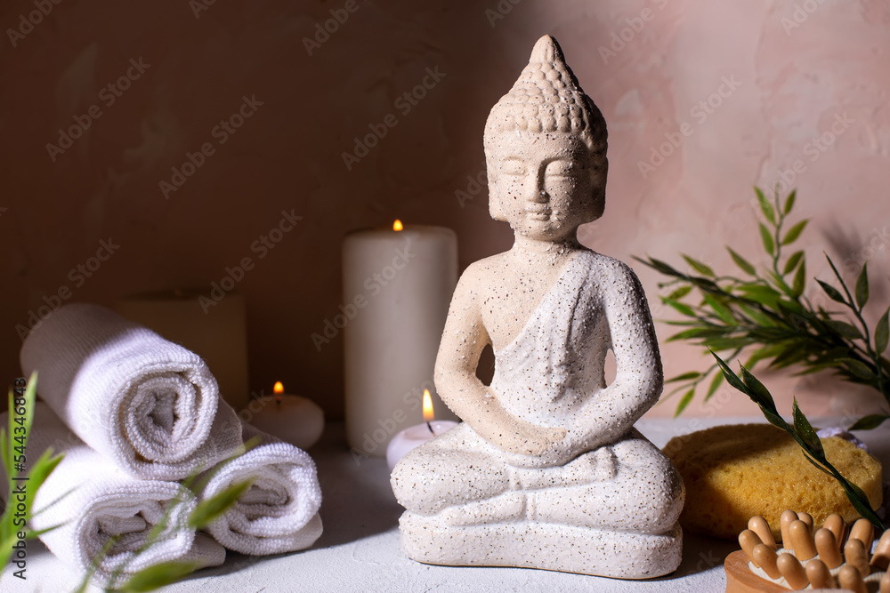 Spa beauty wellness concept with statue of Buddha with burning candles ...