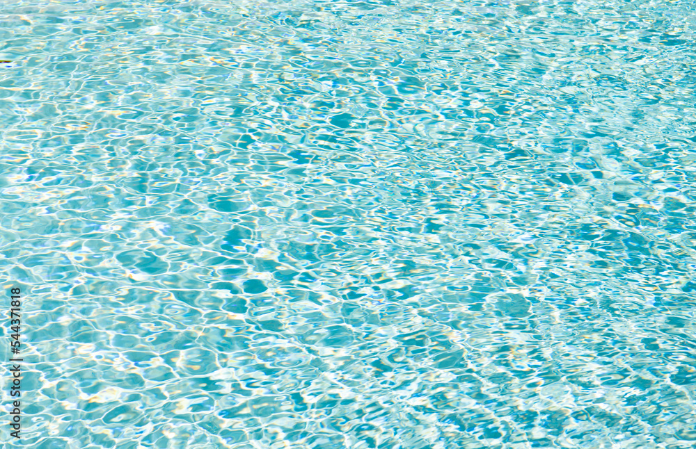 blue color background of swimming pool water with ripples in summer ...