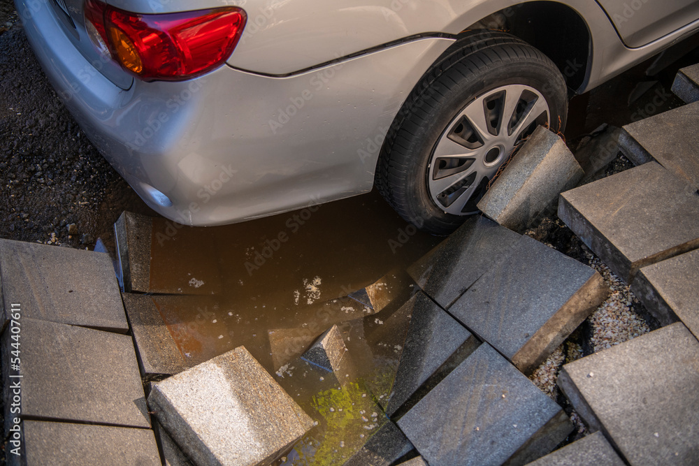 The car fell into a huge sinkhole on broken pavement road surface on ...