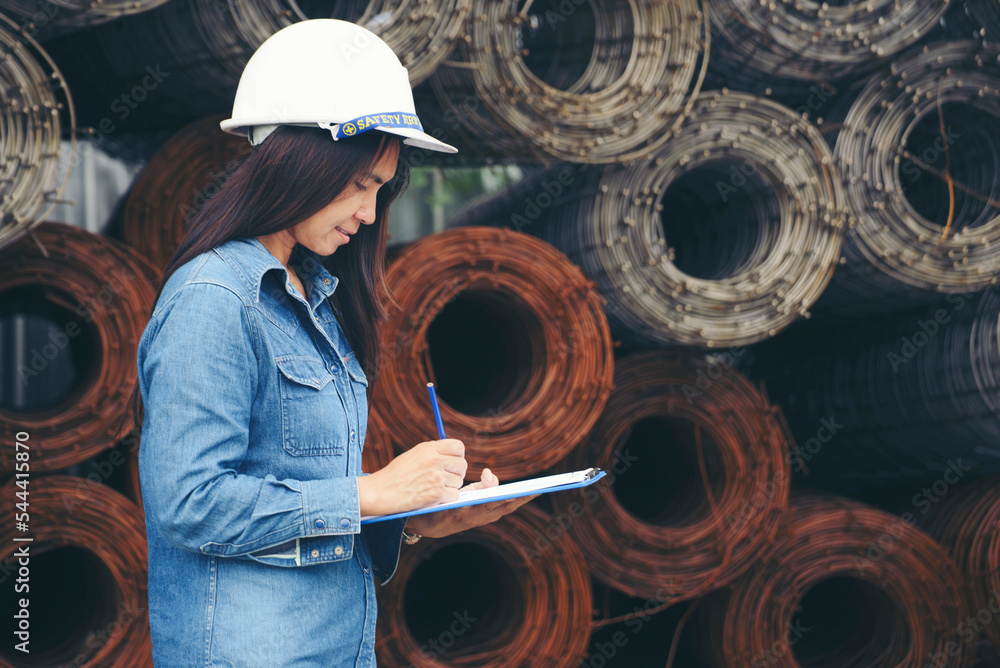 Asian woman engineer fill out form or inspect at construction site ...