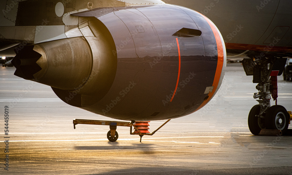 Jet engine under the wing of a modern passenger aircraft at an ...