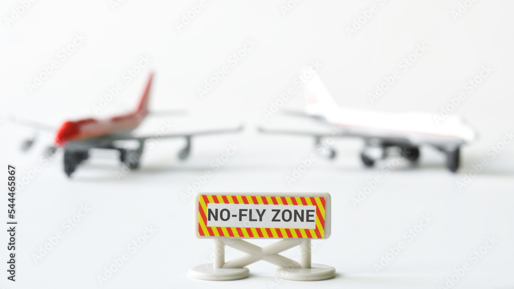 Sign with the inscription no-fly zone next to two toy passenger ...