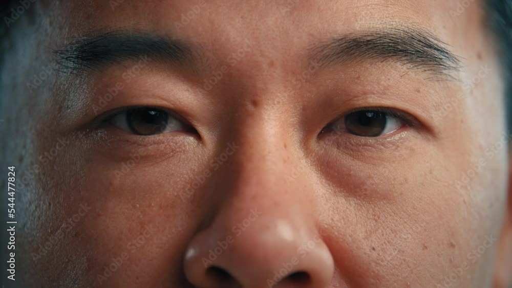 Extreme close-up male eyes korean japanese chinese unhealthy 40s man with sad depressed eyesight ...