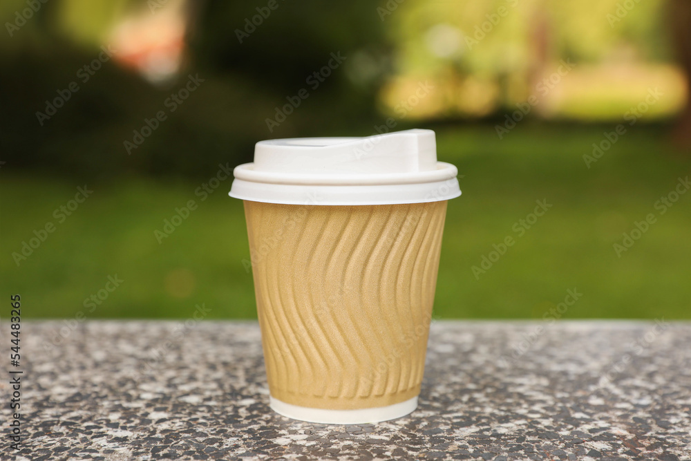 Paper cup on parapet in park, closeup. Coffee to go Stock Photo | Adobe ...