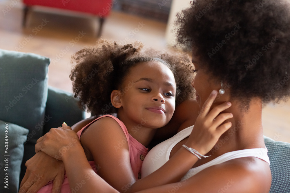 Loving African American mother and daughter hugging. Woman and girl in ...