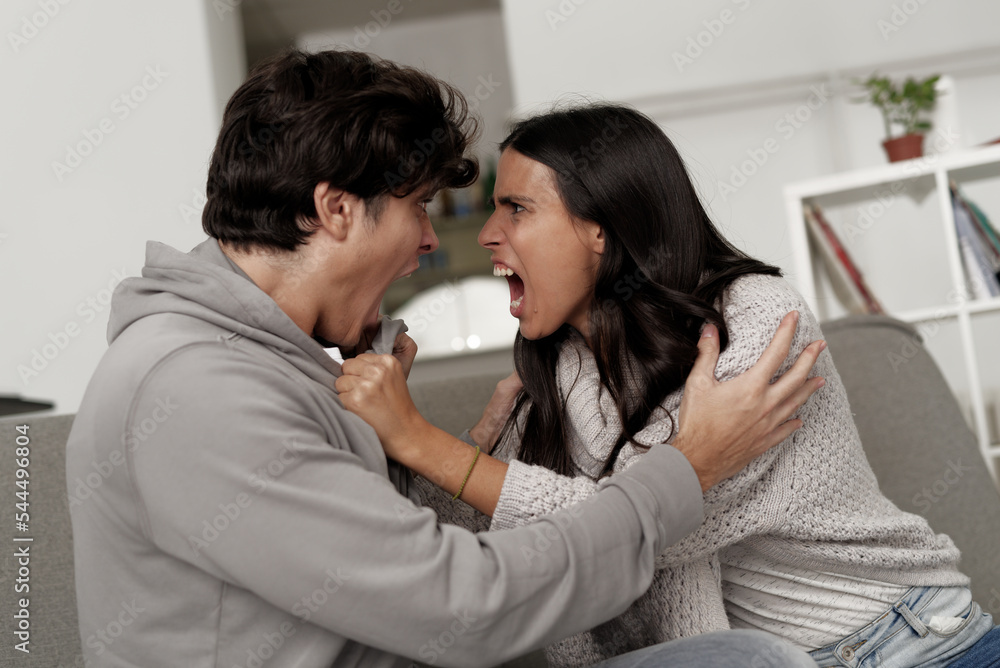 Young married couple violently fighting, wife and husband screaming at ...