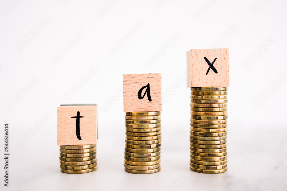 Tax text on top of growing stacks of coins, increasing tax rates and ...