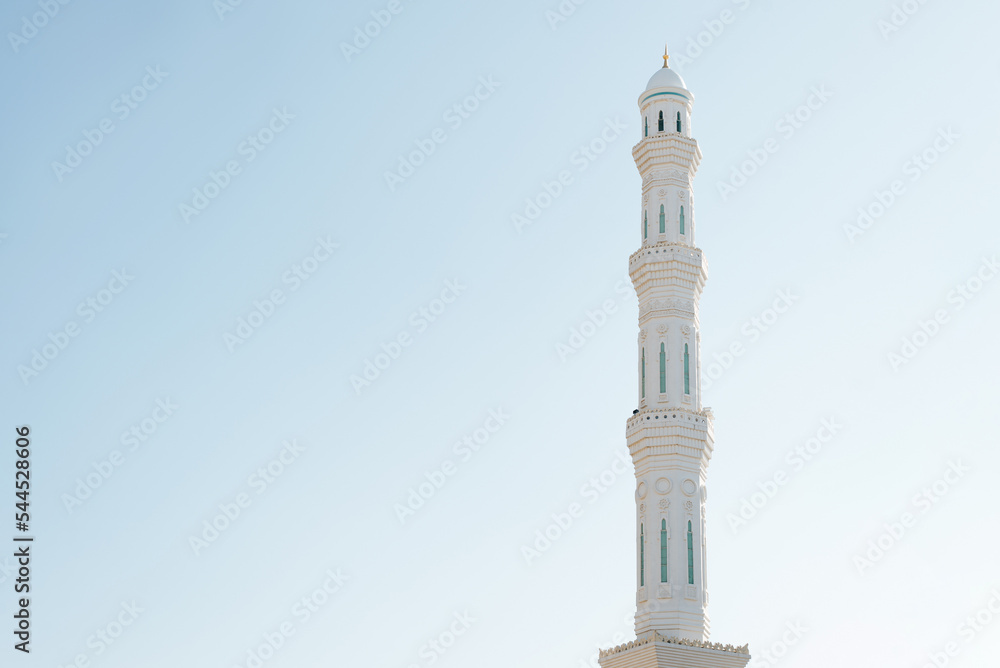 White beautiful minaret, religious tower for notification of prayer ...