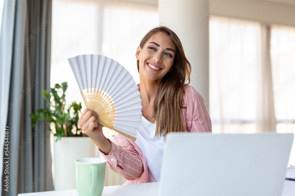 Tired overheated young woman hold wave fan suffer from heat sweating ...