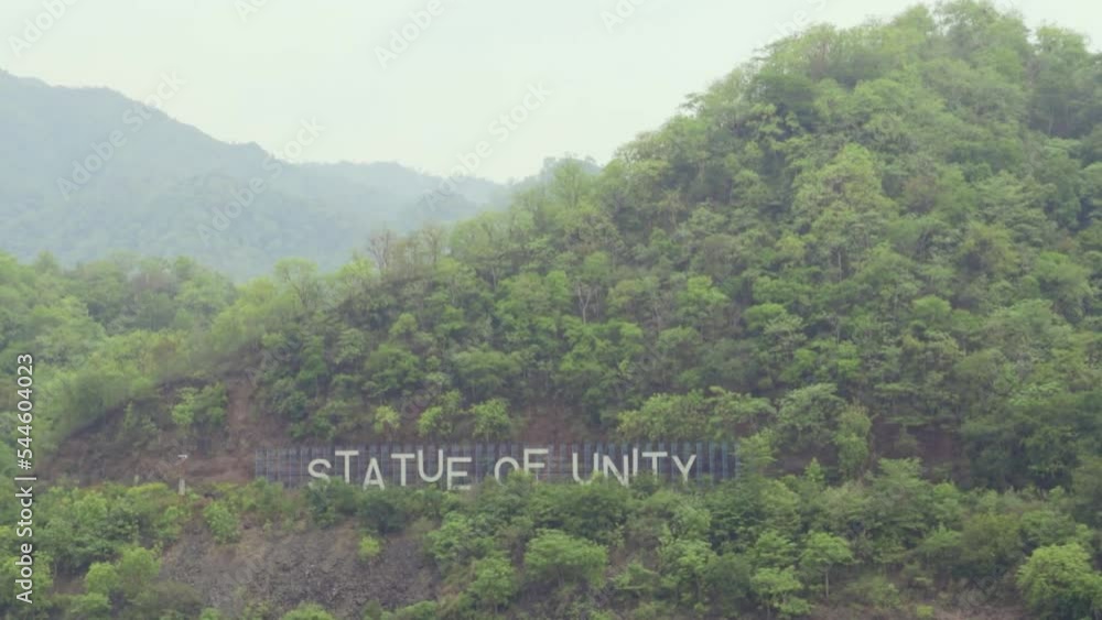 statue of unity board written at green mountain with river at morning ...