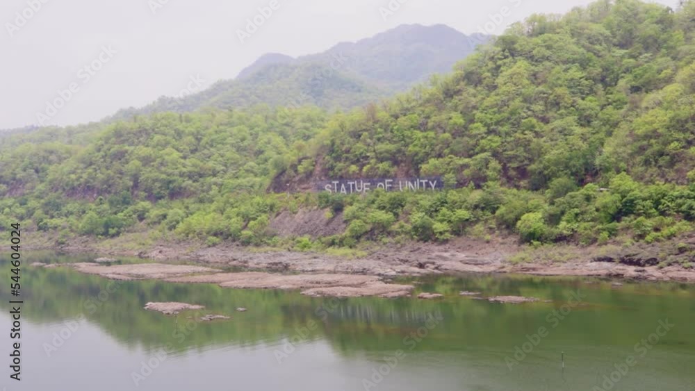 statue of unity board written at green mountain with river at morning ...