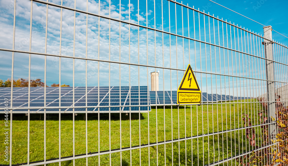 Danger high voltage attention sign on the exterior electric fence ...